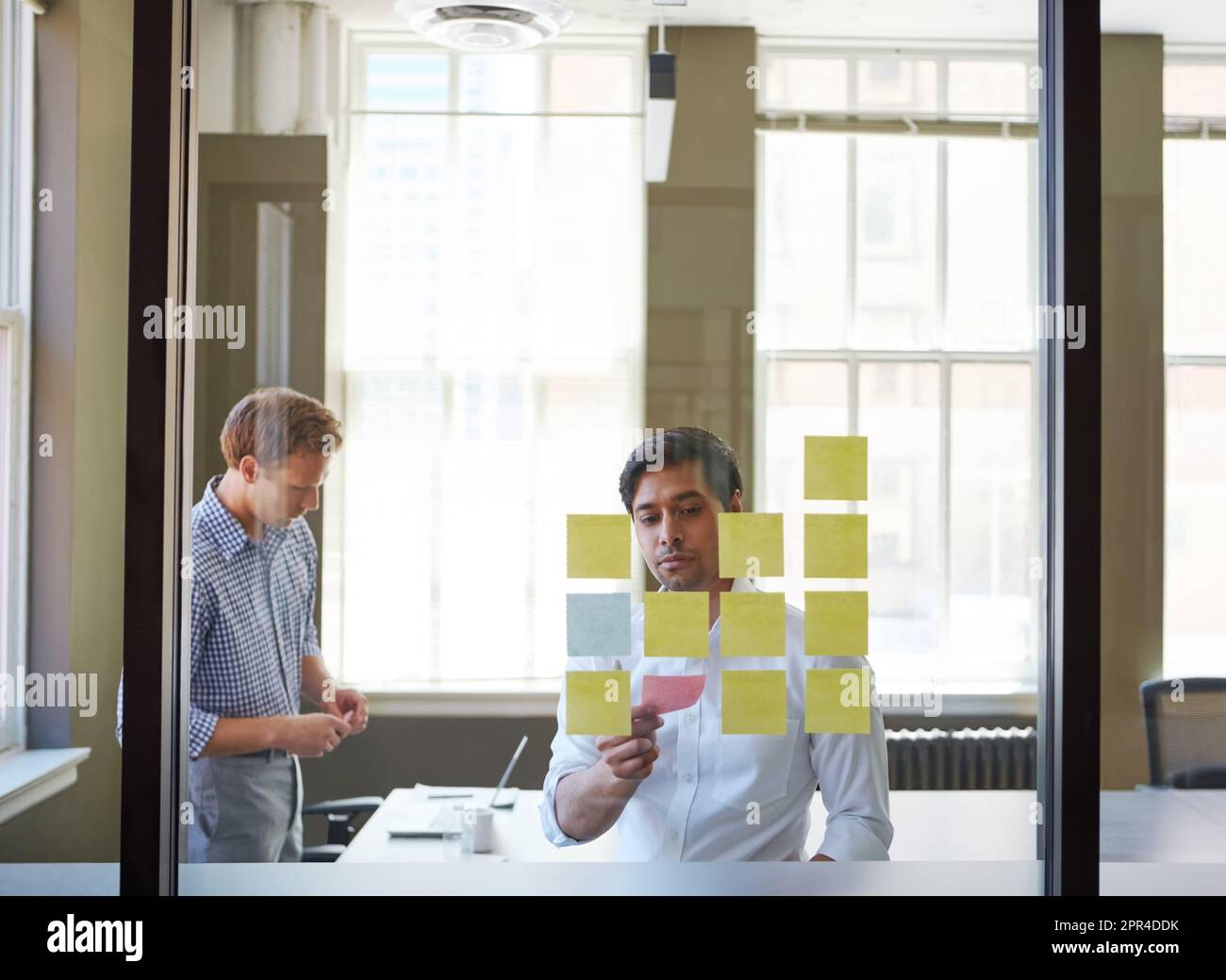 What it all adds up to is a sure success. two businessmen preparing for ...