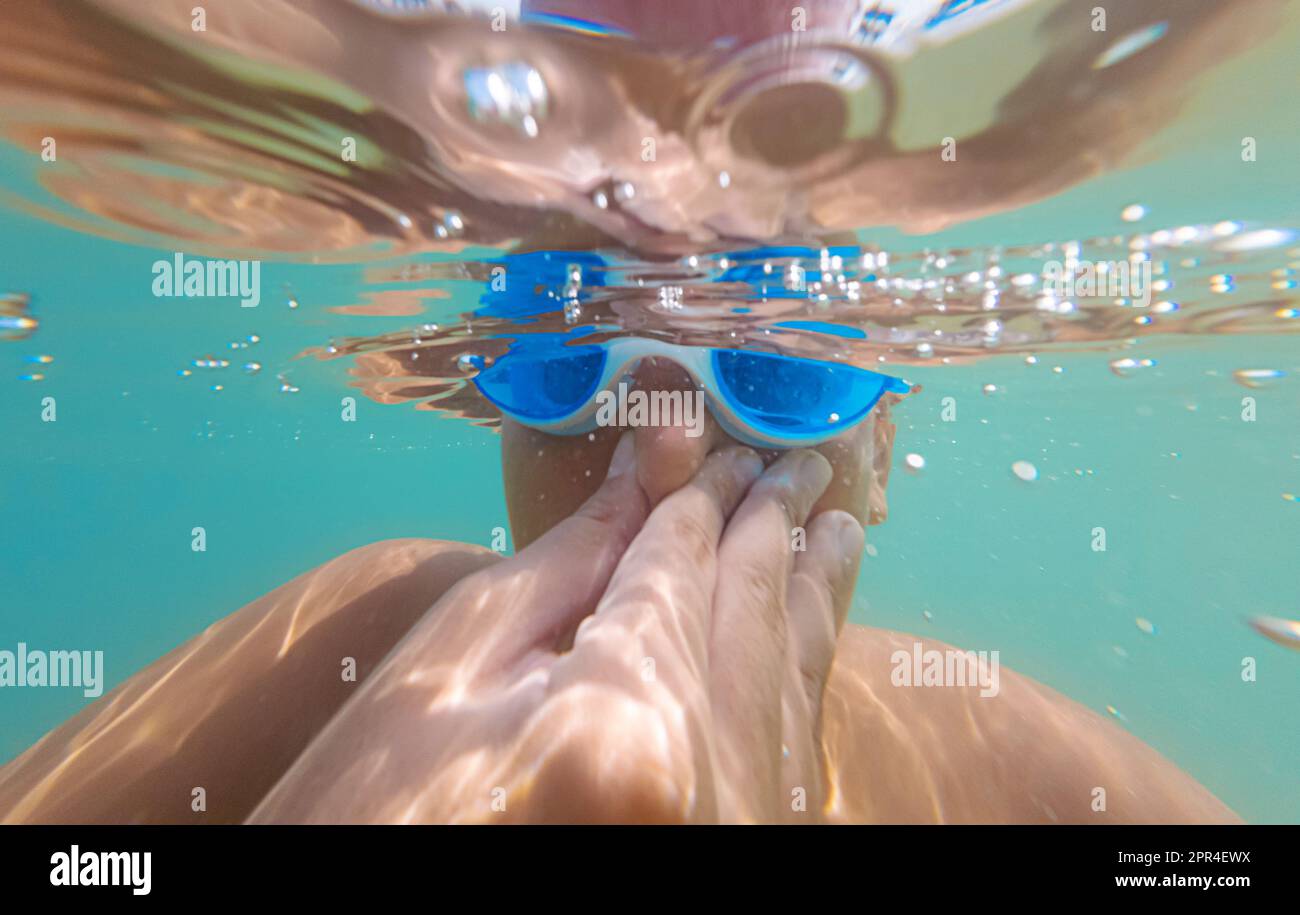 Teenage boy having fun under sea. Summer enjoyment concept Stock Photo ...