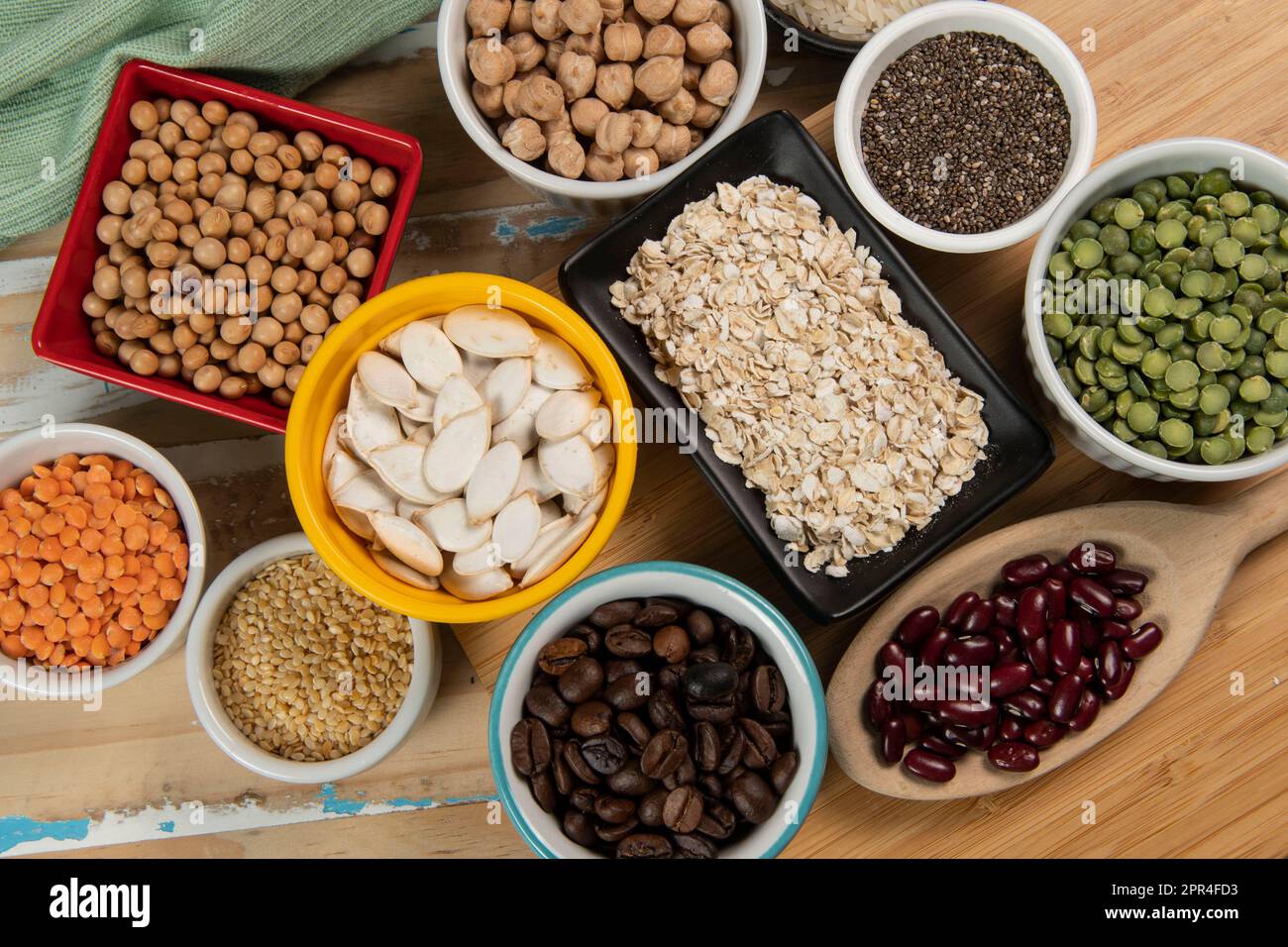 Different types of legumes in bowls, green and yellow peas, chickpeas ...