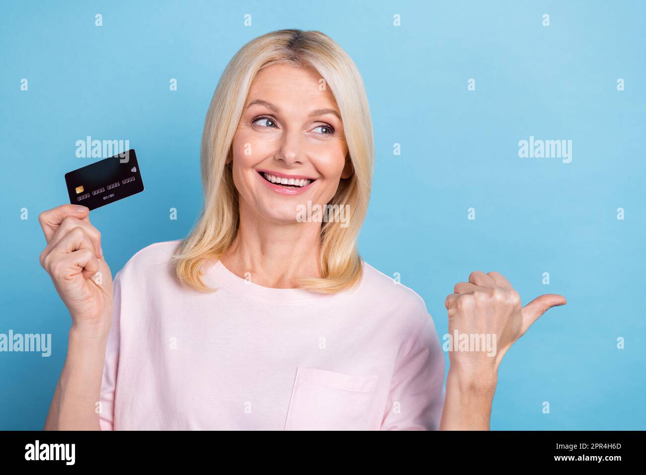 Photo of charming aged lady hold debit card look direct finger empty ...