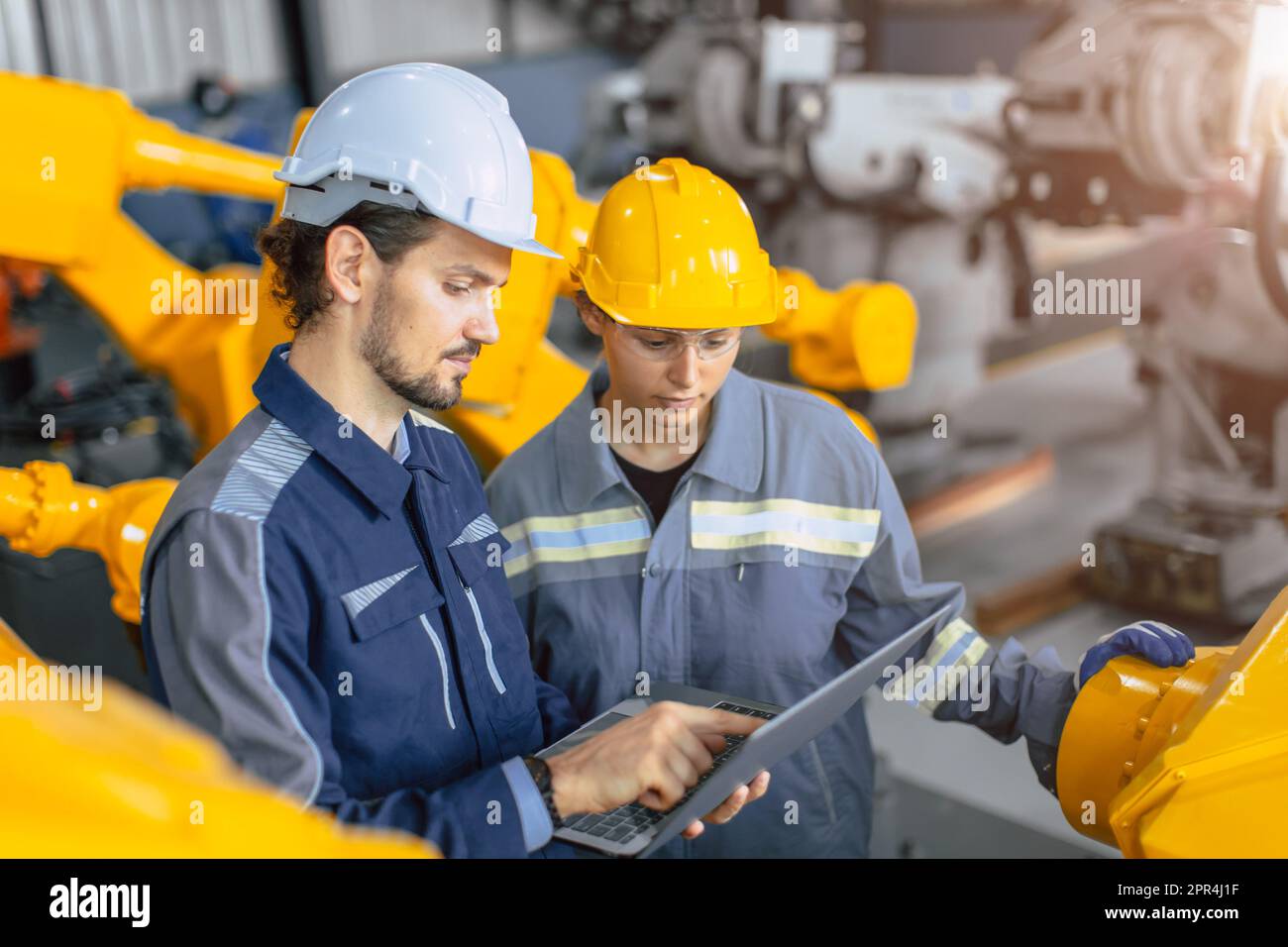 engineer team working together inspection quality robot arm in robot assembly industry plant ...