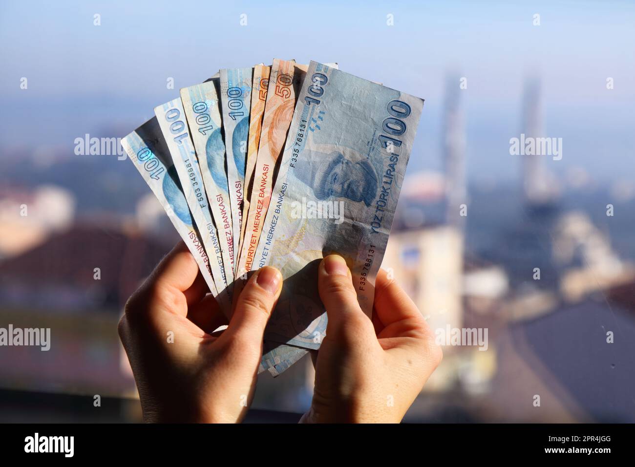 Turkish lira. Currency of Turkey - hand holding used banknotes. Turkish ...