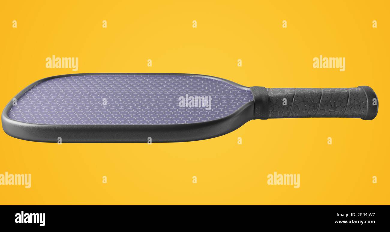 Pickleball racket with black leather handle on yellow background. Close ...