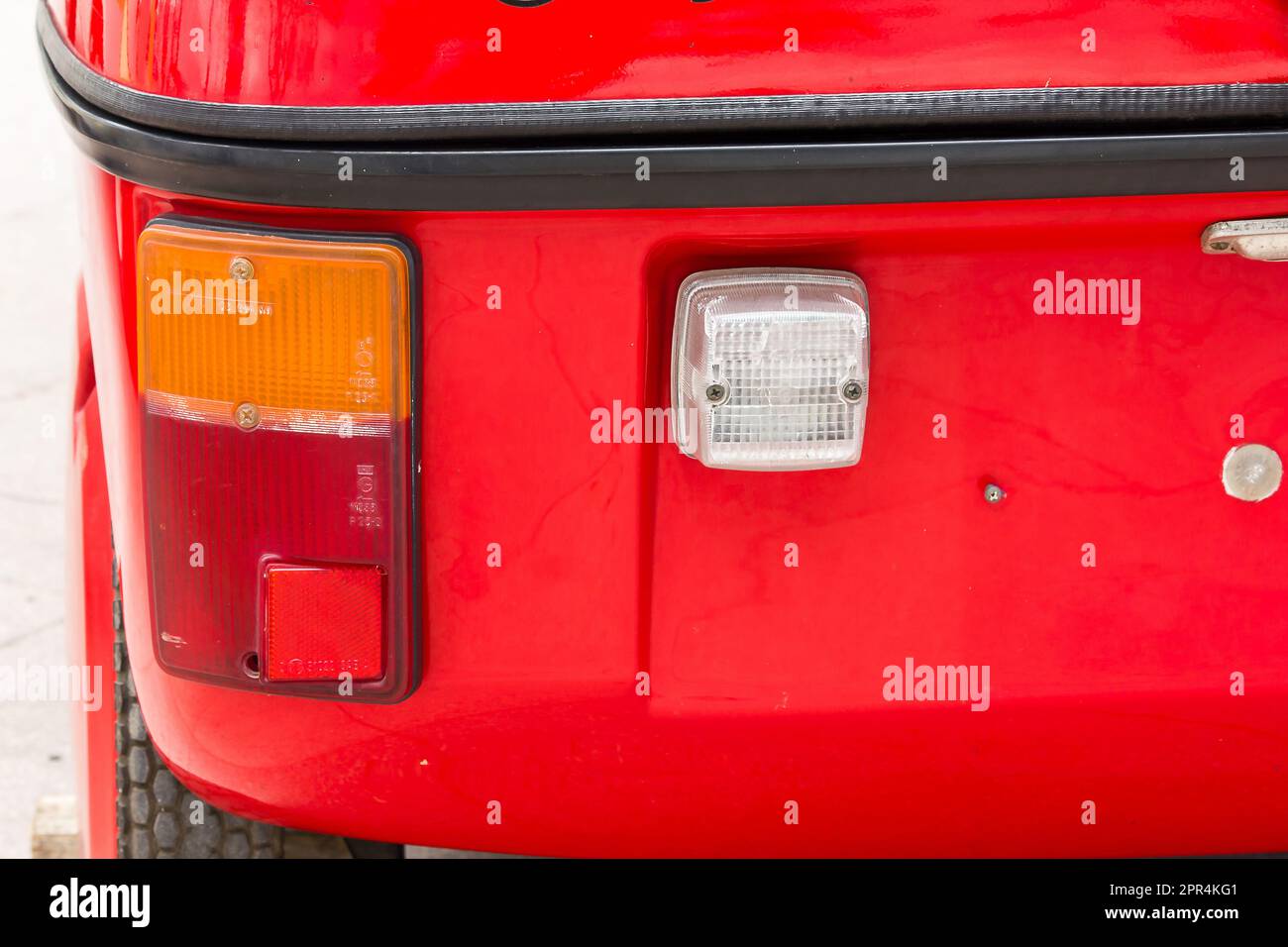 The lights turn on the left side of the red vintage car Stock Photo - Alamy