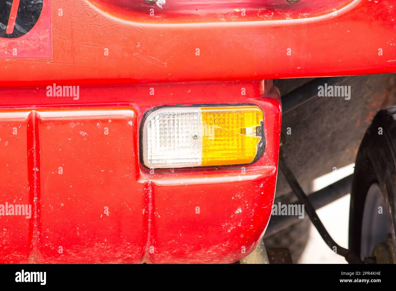 The lights turn on the left side of the red vintage car Stock Photo - Alamy