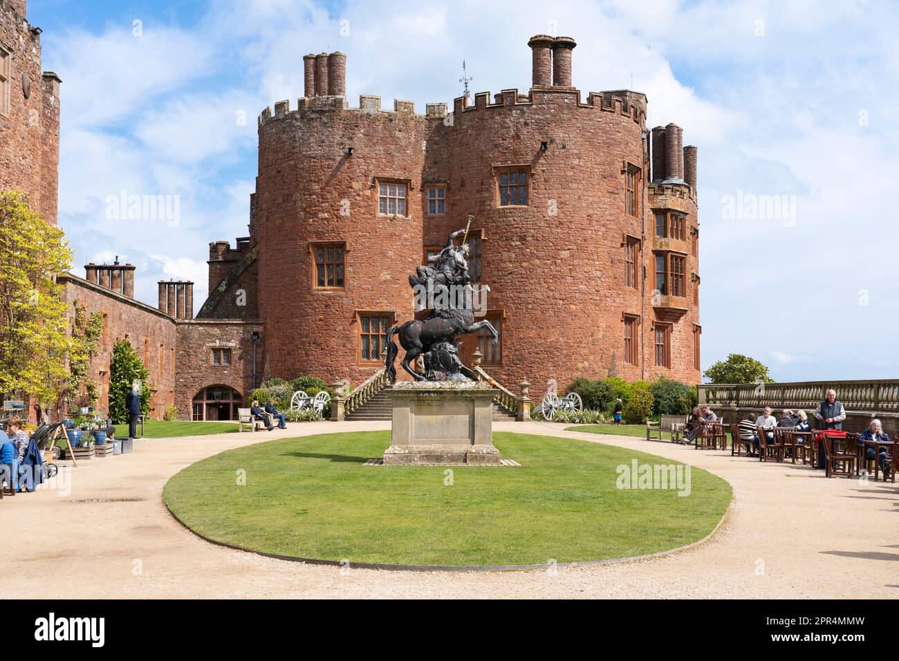 People in the outer courtyard of Powis Castle, a medieval fortress ...