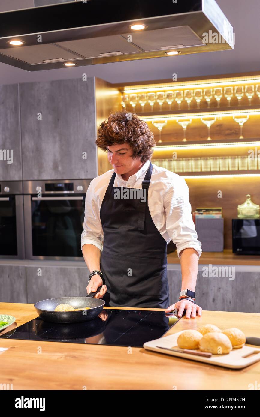 Portrait happy chef frying burger buns for a dinner party in the ...