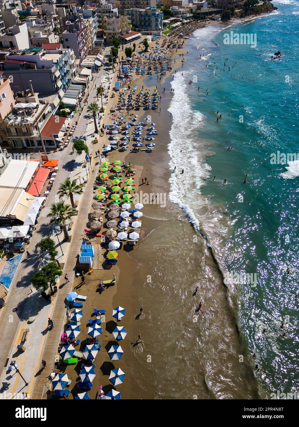 Aerial view of a busy beach in the popular resort town of Nea Chora in ...