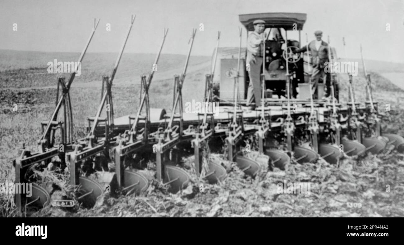 Furrow oil tractor plough at work The early twentieth century is ...