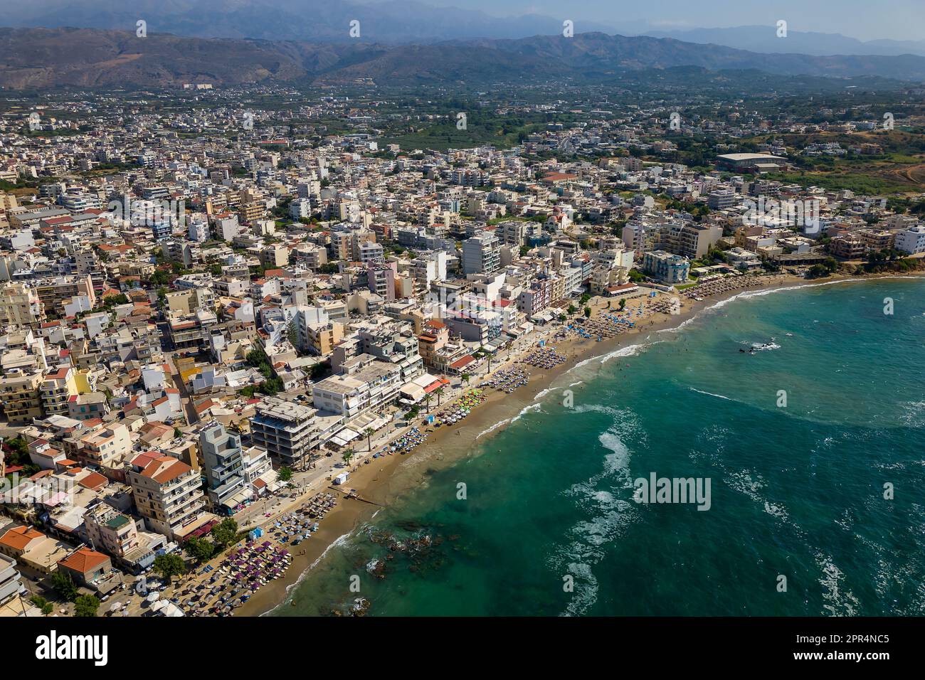 Aerial view of a busy beach in the popular resort town of Nea Chora in ...