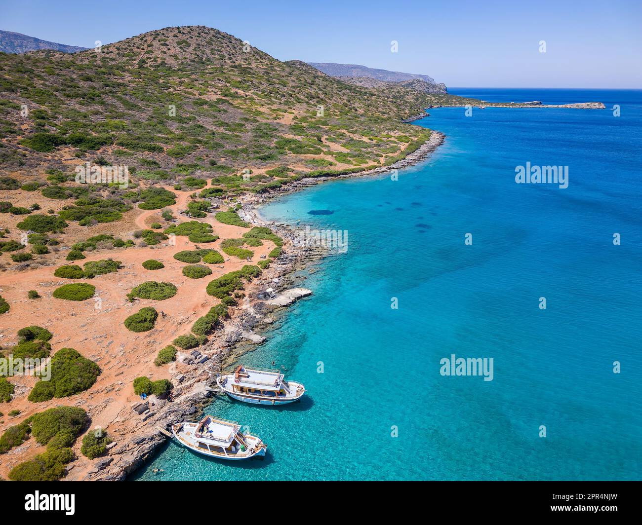 Aerial view of tourist boats and swimmers in crystal clear waters off a ...