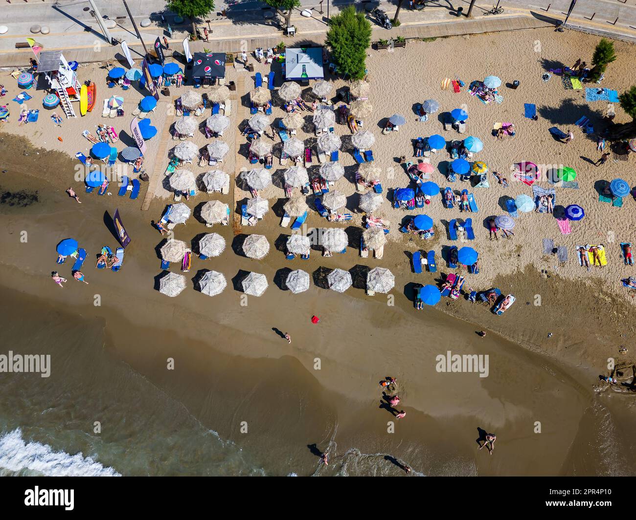 Aerial view of a busy beach in the popular resort town of Nea Chora in ...