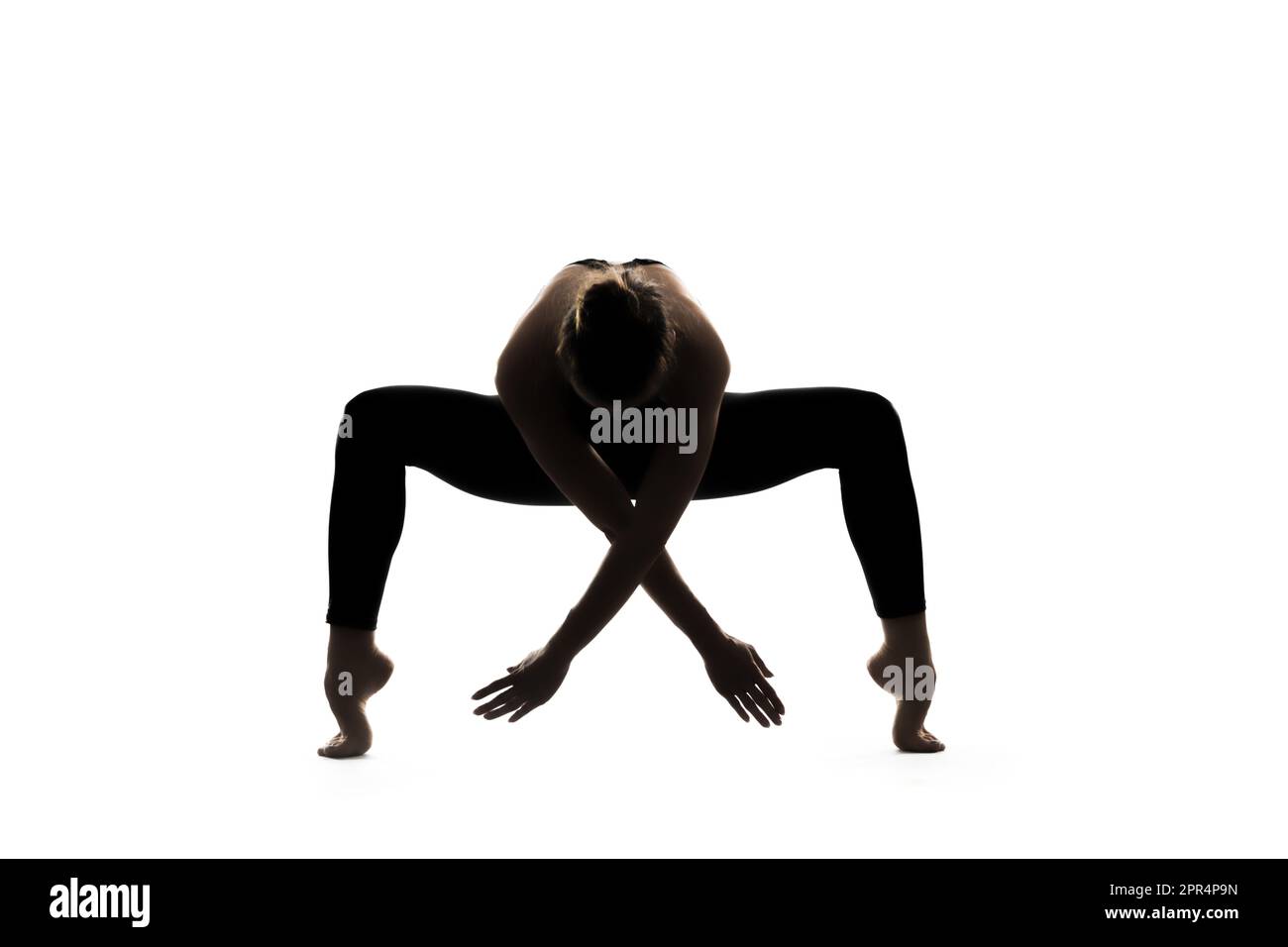 A woman in a yoga pose with her arms extended on a white background ...