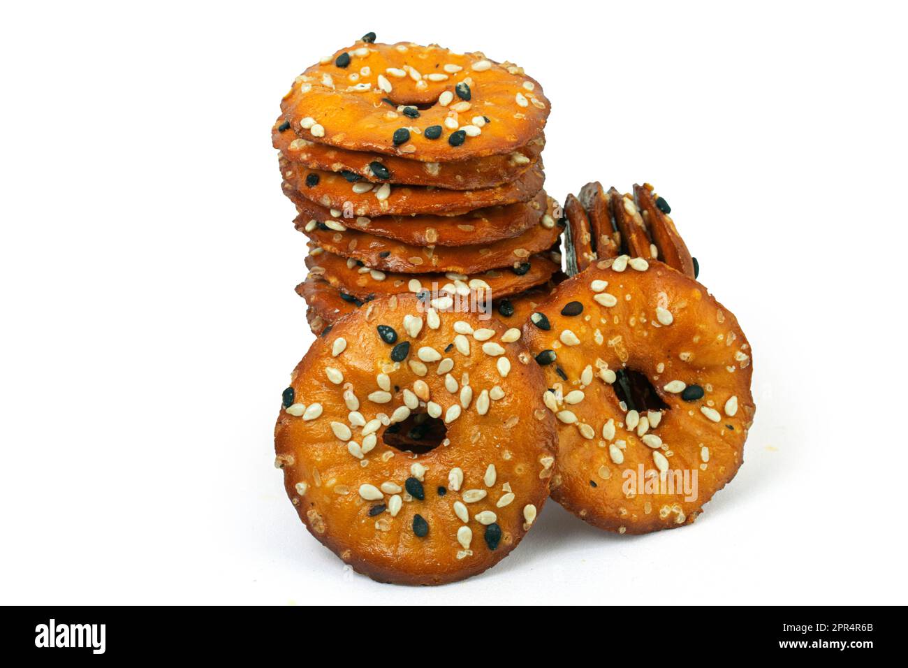Round salty pretzels wtih black and white sesame isolated on white ...