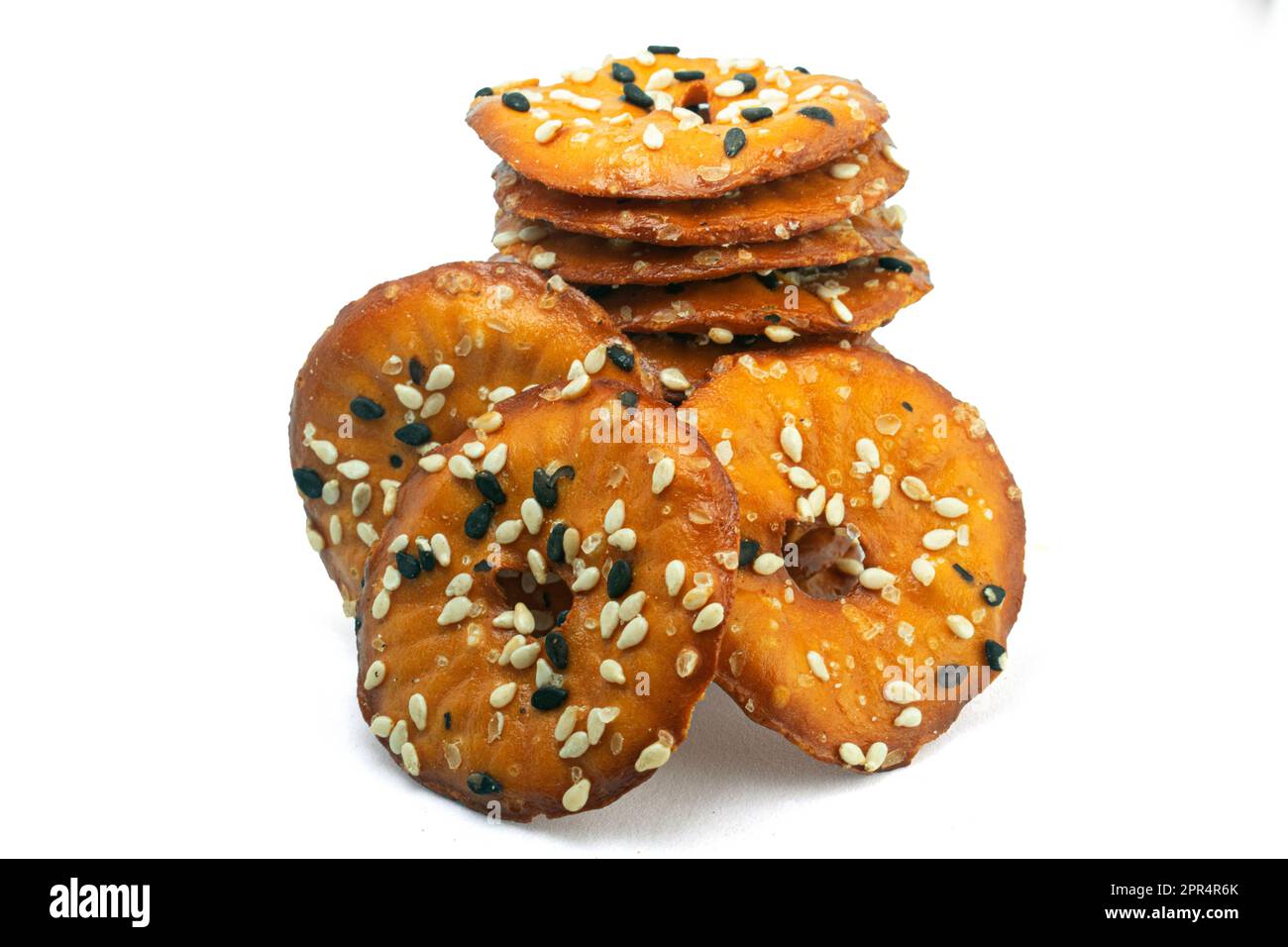 Round salty pretzels wtih black and white sesame isolated on white ...
