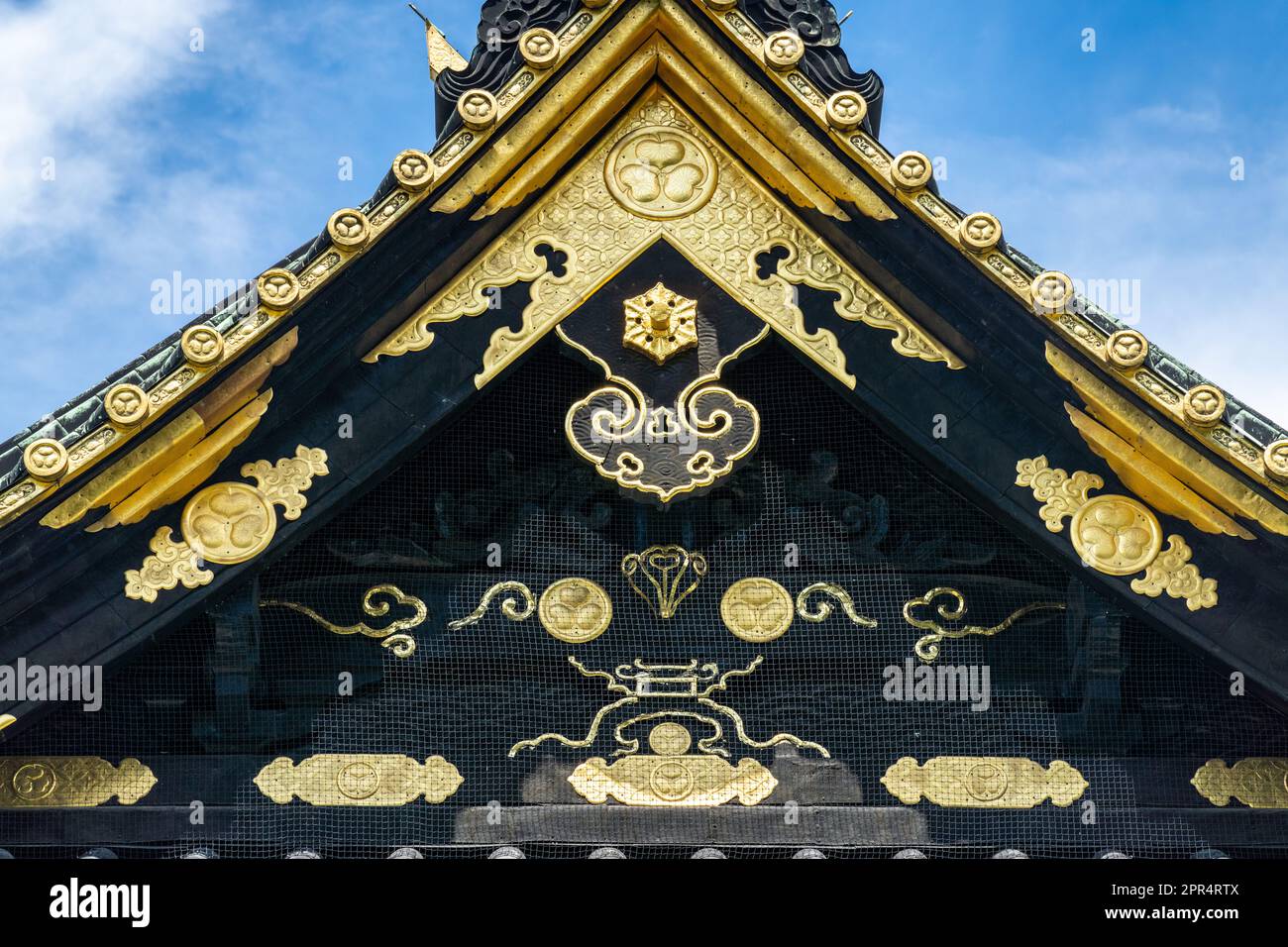 Details of the ornate gold elements on the roof gable of the Ueno Tosho ...