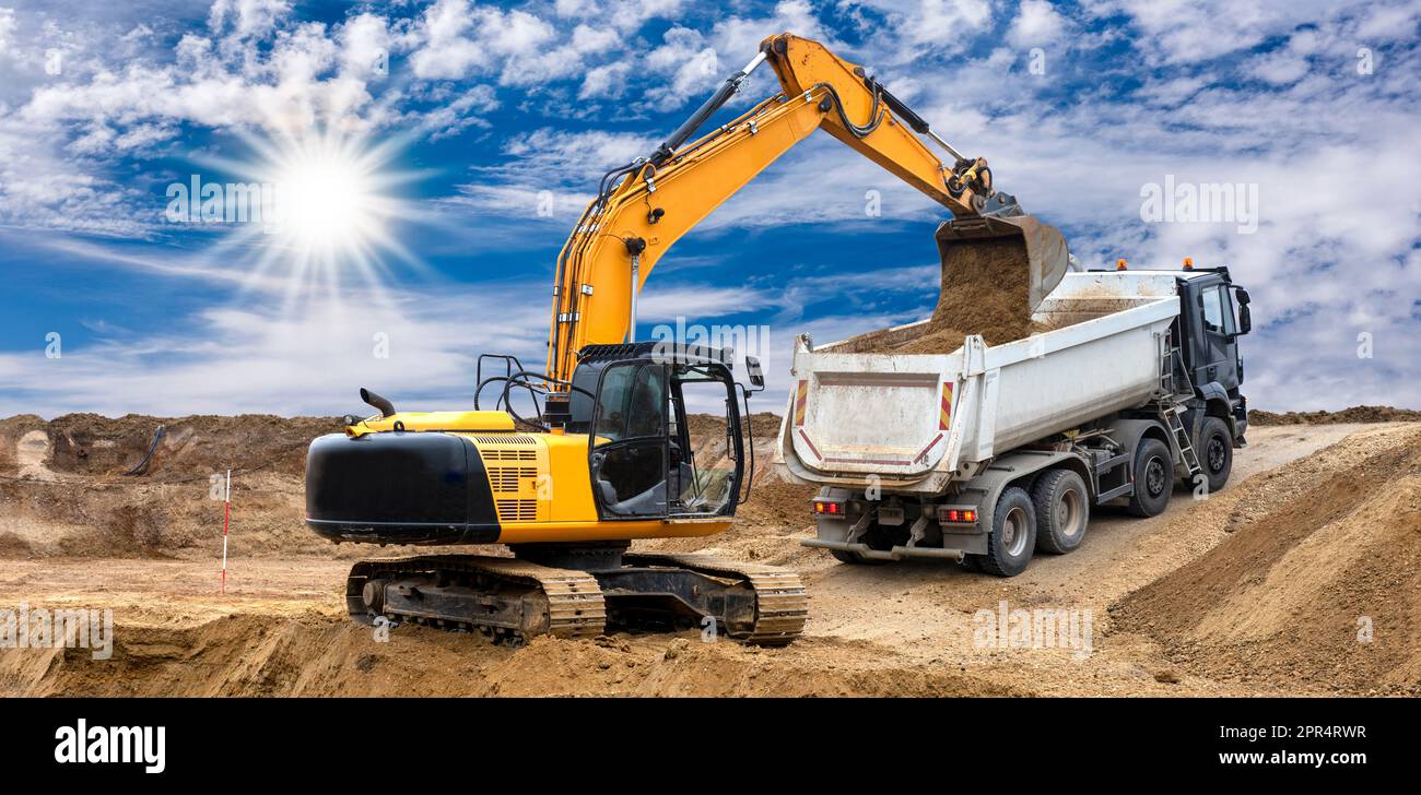 excavator is working and digging at construction site Stock Photo - Alamy