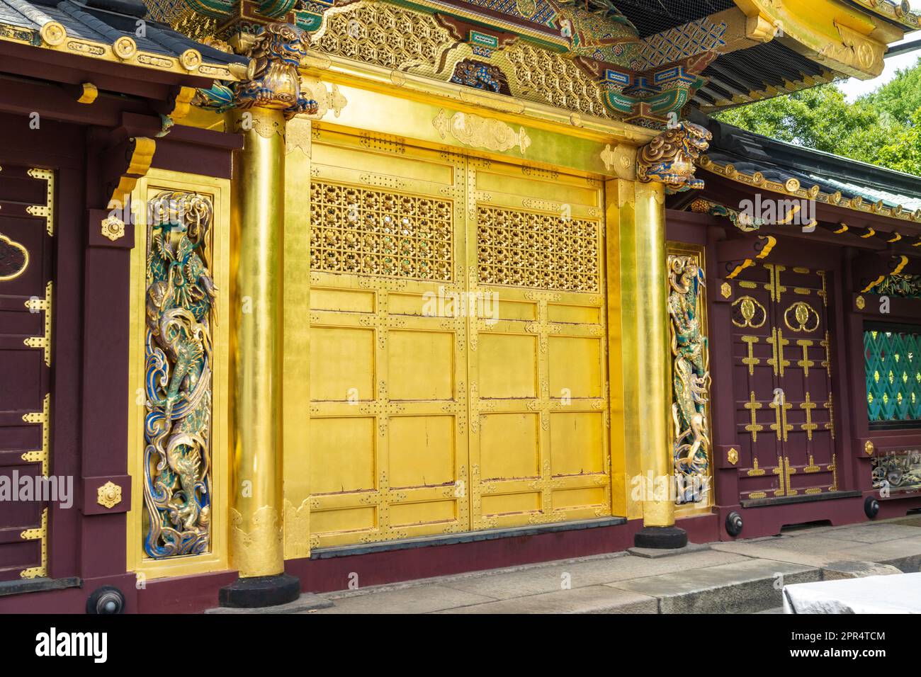 The ornate golden Karamon gate with the ascending and descending dragon ...