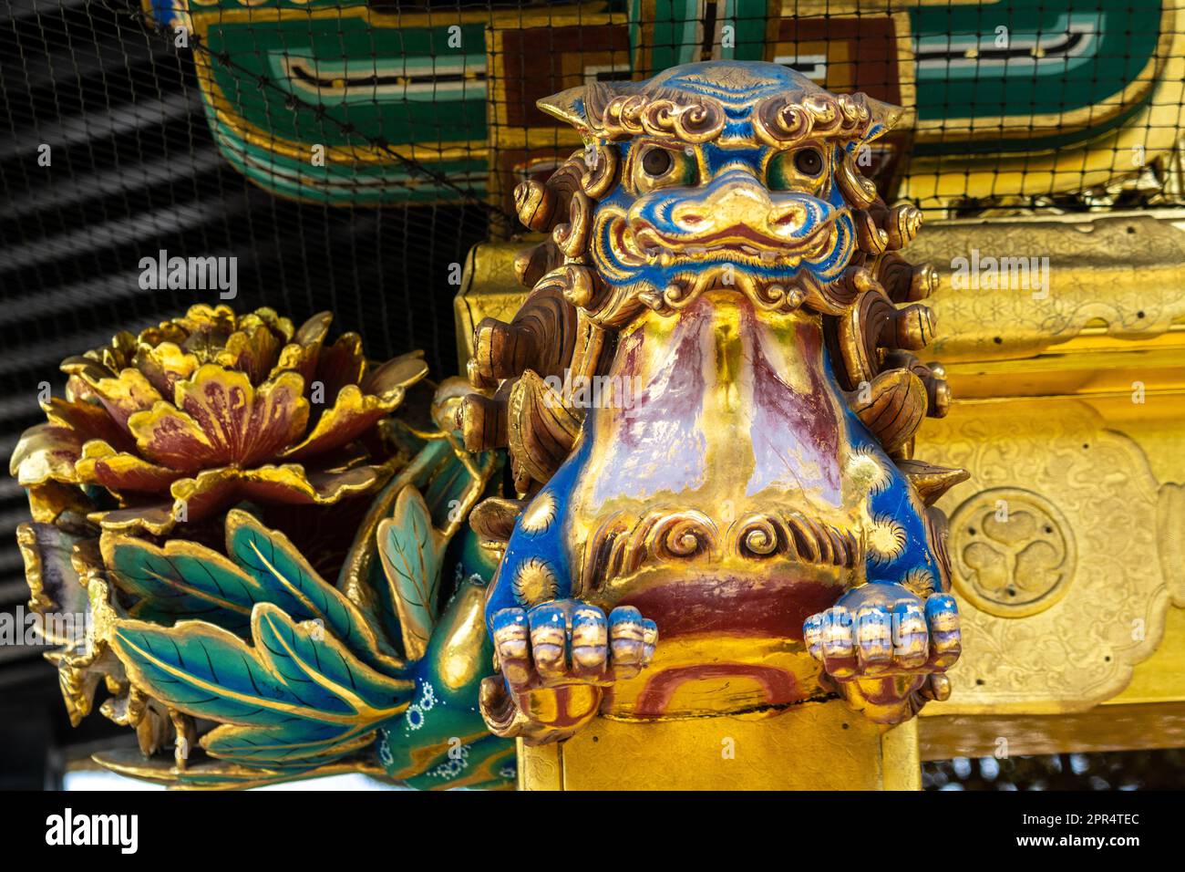Detail of a wooden lion carving on a pillar at the Ueno Tosho-gu Shrine ...