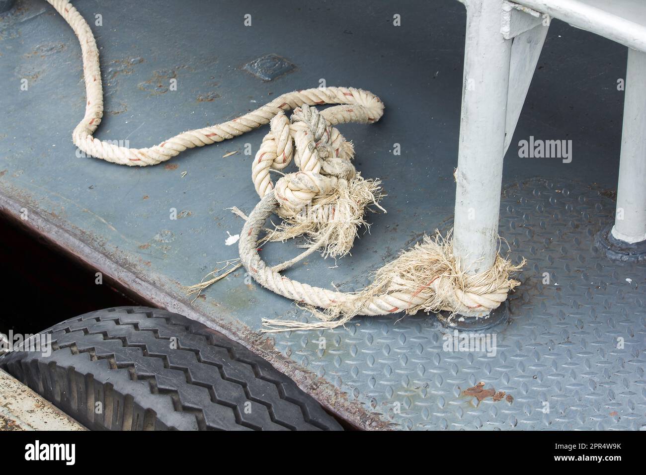 Old rope tied to the ship's steel pole Stock Photo - Alamy