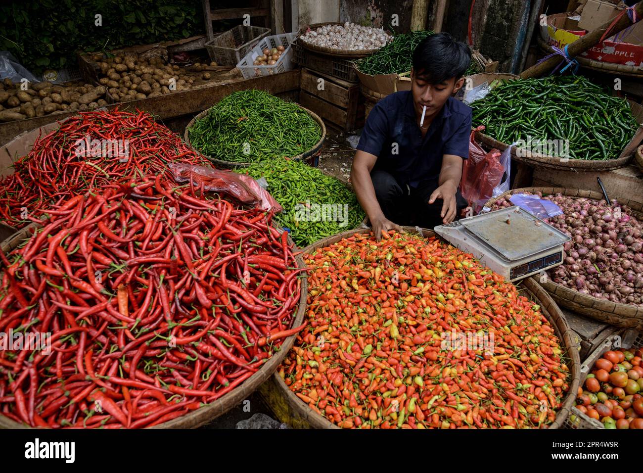 Bogor, West Java, Indonesia. 26th Apr, 2023. A chilli vendor waits for ...