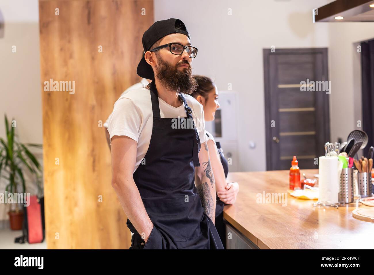 Happy confident young waiter entrepreneur looking at camera, smiling ...
