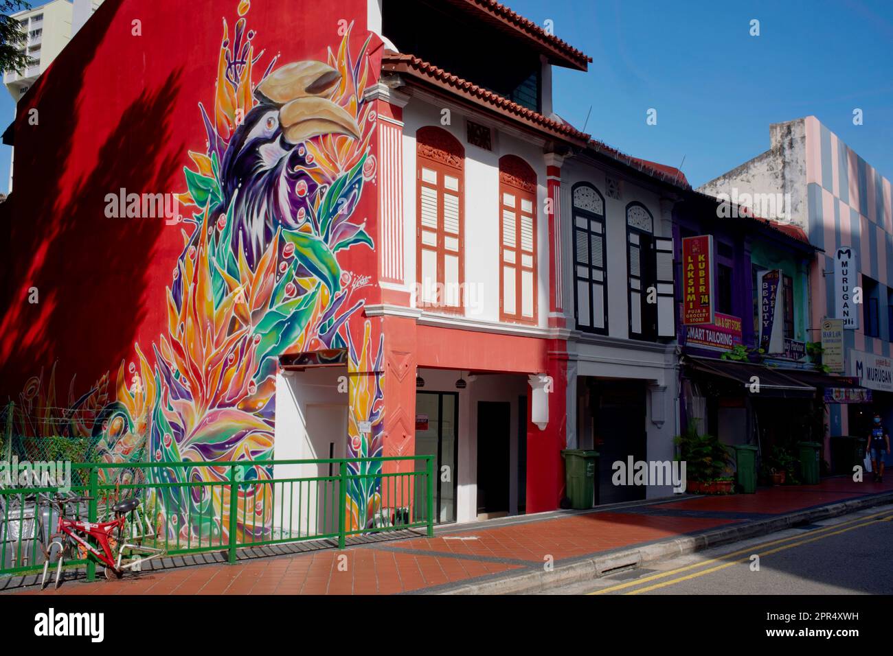 A colorfully painted traditional Chinese shophouse with latticed ...
