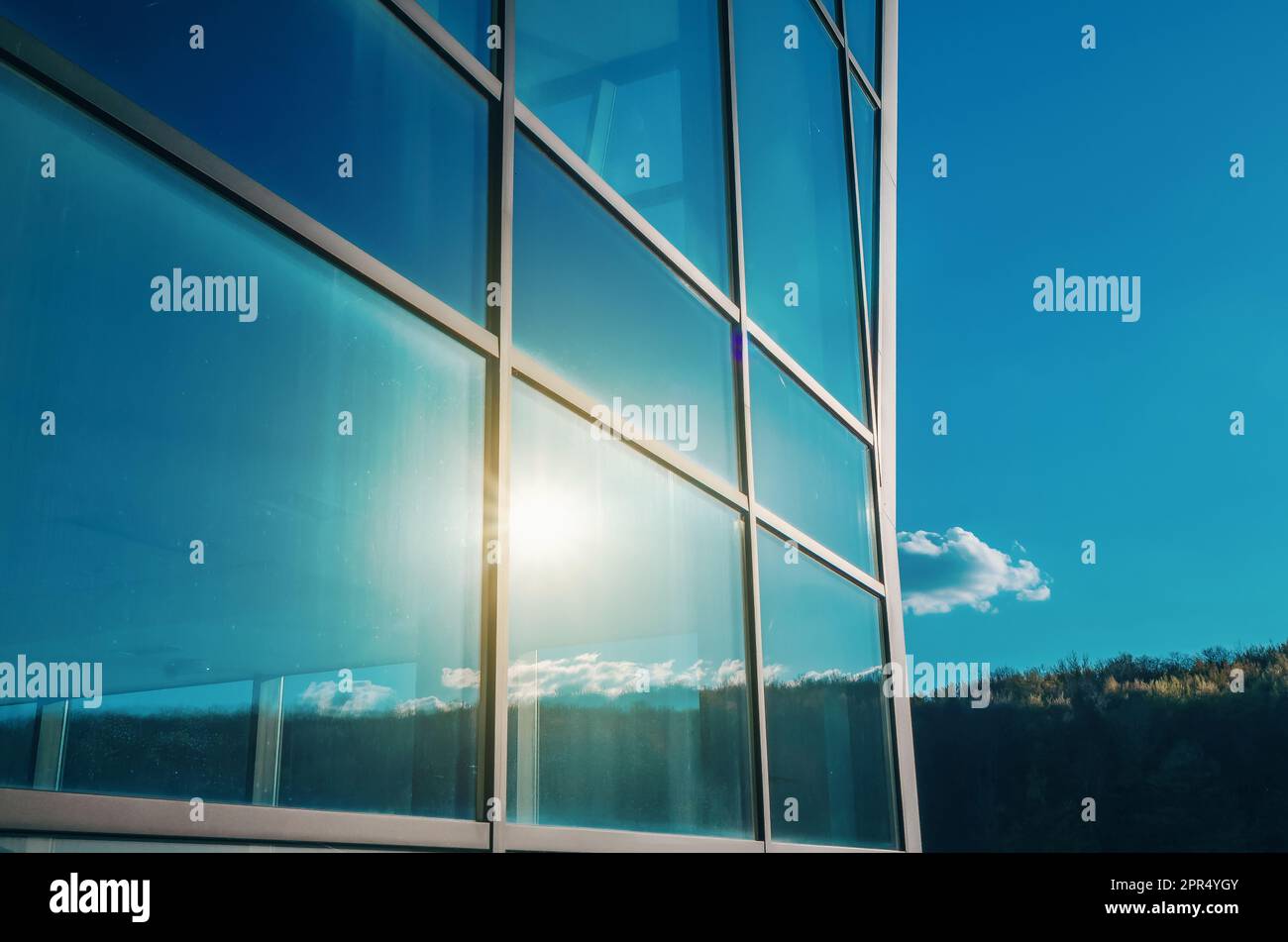 Glass windows of a modern building. Sunlight is reflected in glass ...