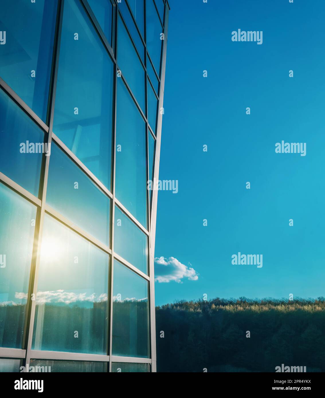 Glass windows of a modern building. Sunlight is reflected in glass ...