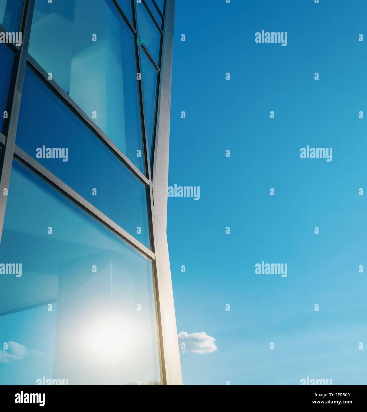 Glass windows of a modern building. Sunlight is reflected in glass ...