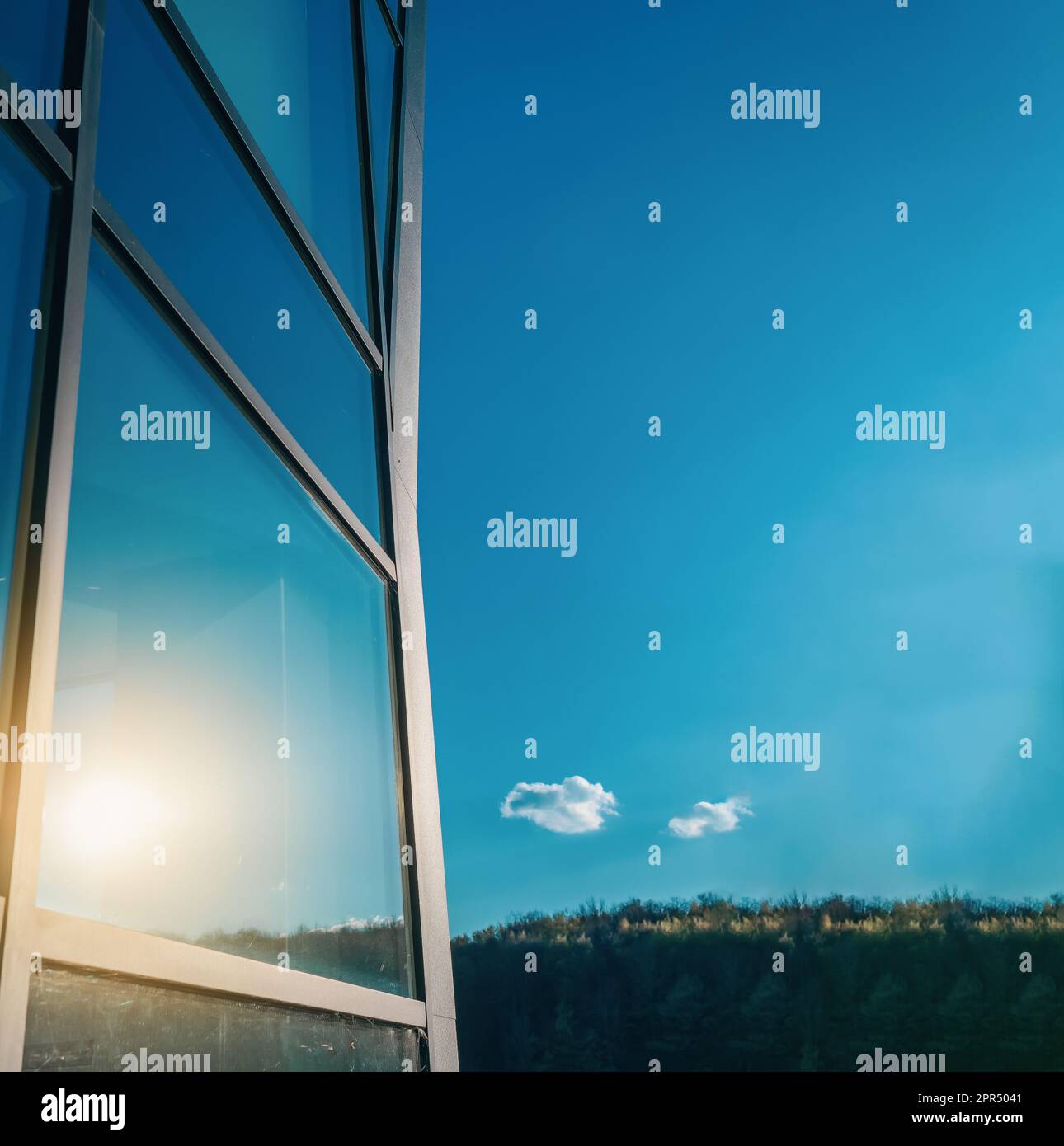 Glass windows of a modern building. Sunlight is reflected in glass ...