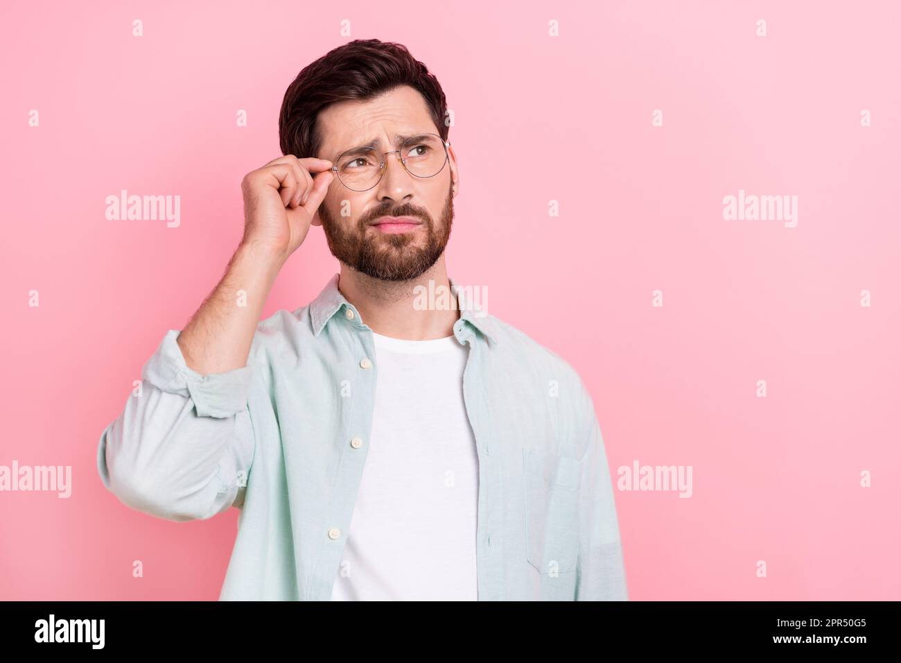 Photo portrait of nice young male touch specs look skeptical empty ...