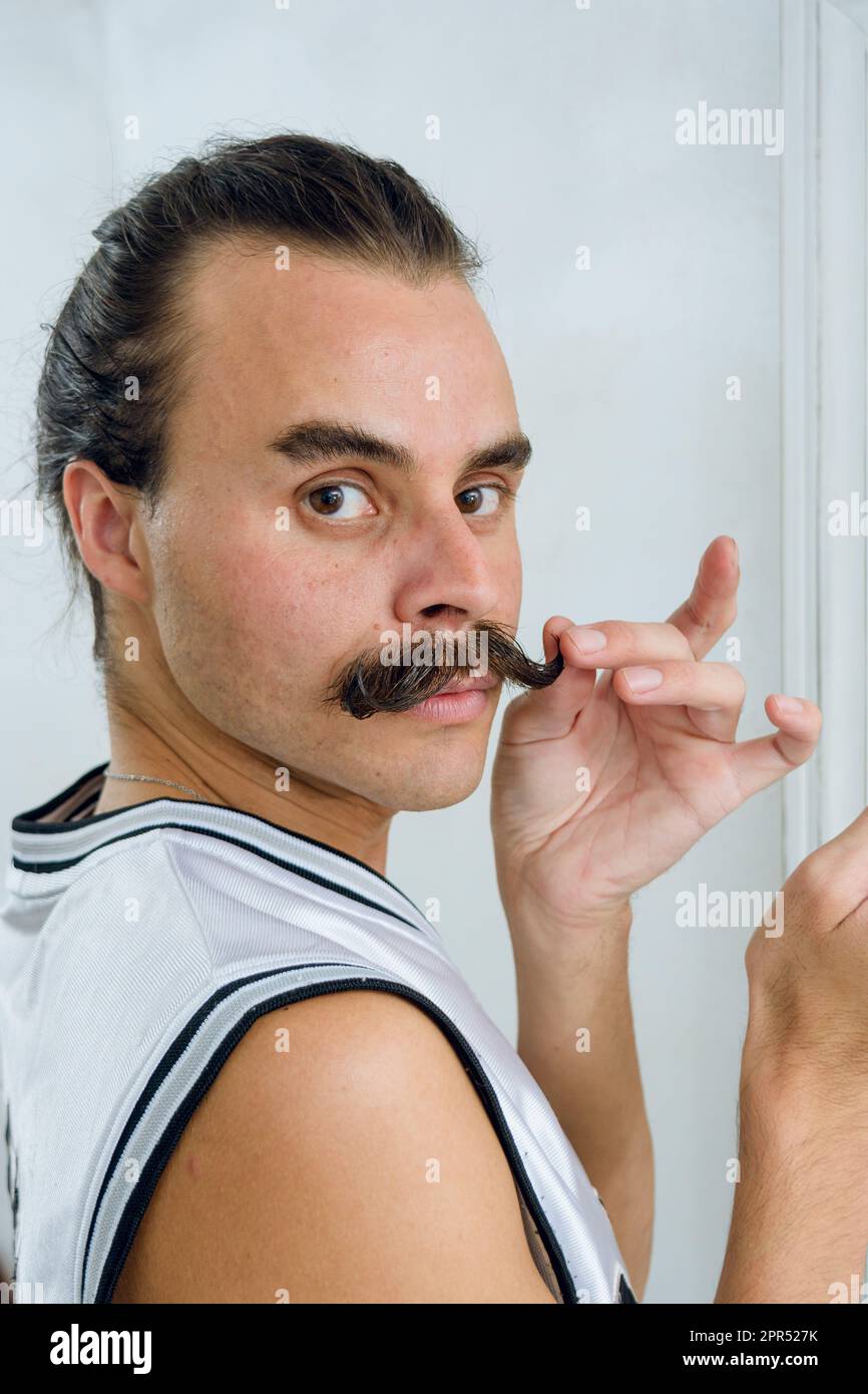 portrait of a young non-binary latino person in his room who turned to ...