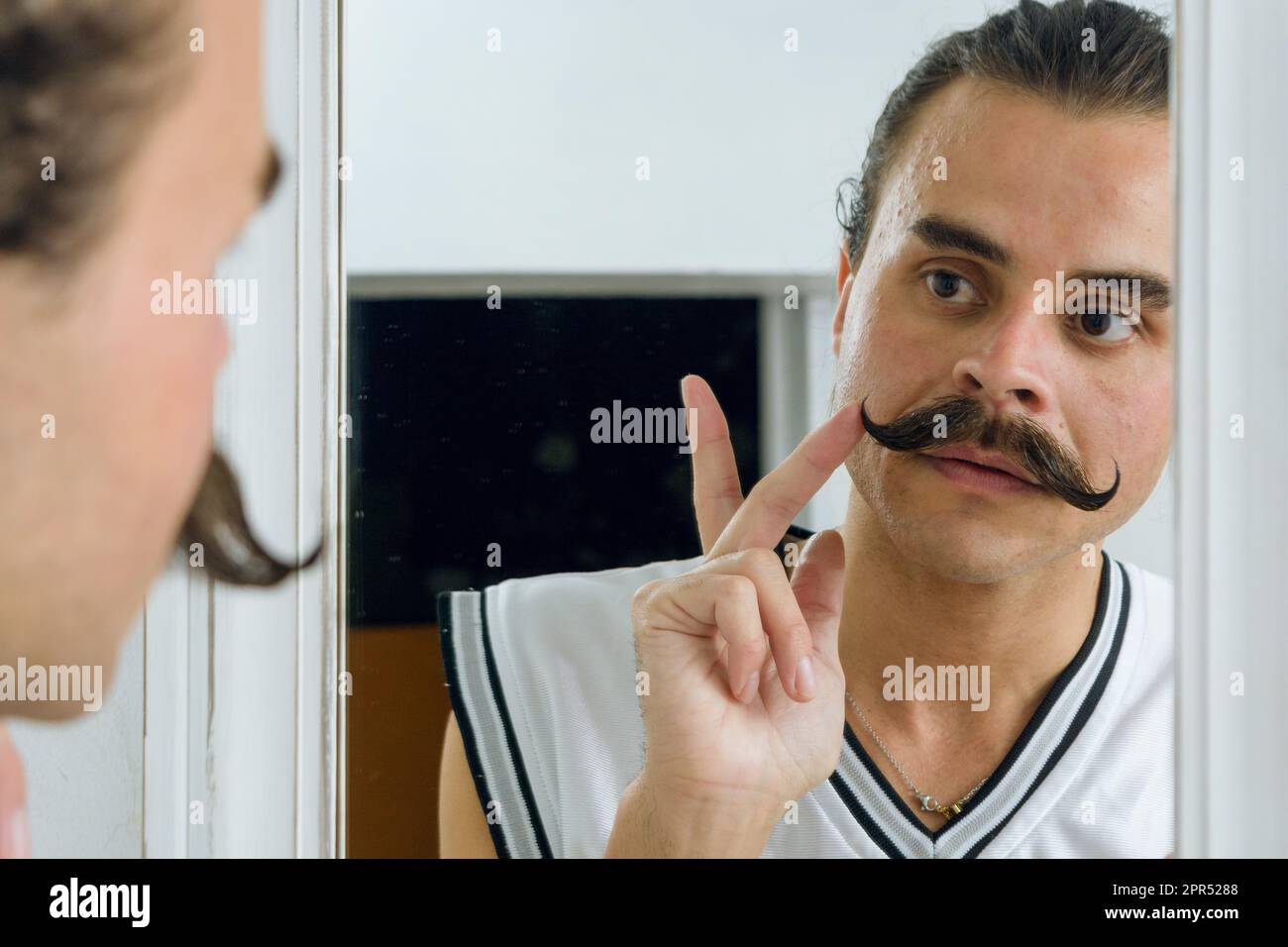 Reflection of a young Latino person of non-binary gender, very serious ...