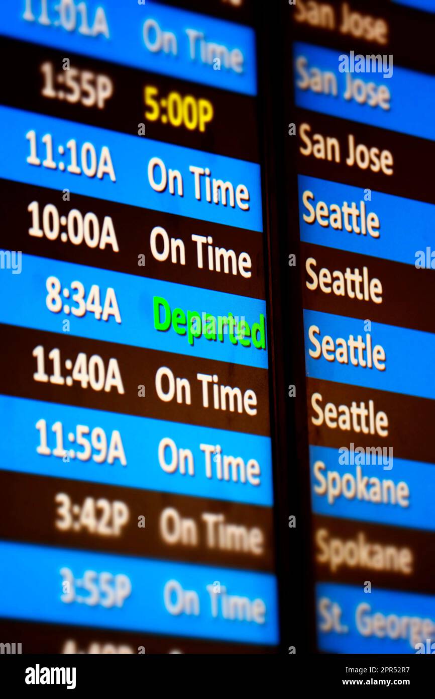 Airline flights information board in airport with arrivals and ...