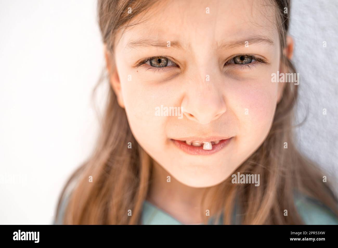 Charming smiling little girl kid with opened mouth shows staggering ...