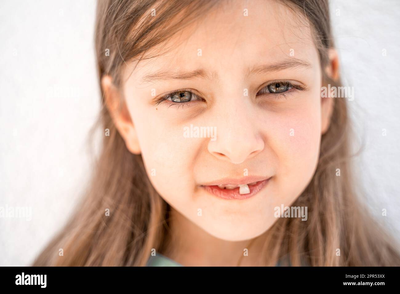 Charming smiling little girl kid with opened mouth shows staggering ...