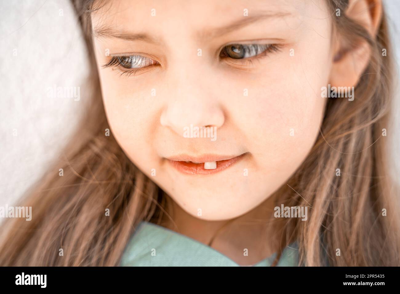 Charming smiling little girl kid with opened mouth shows staggering ...
