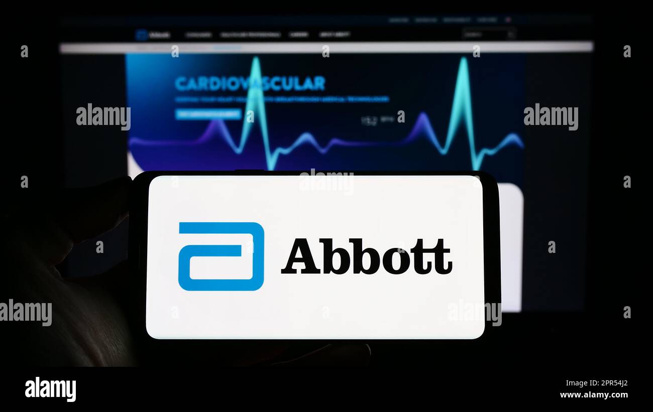 Person holding smartphone with logo of US healthcare company Abbott ...