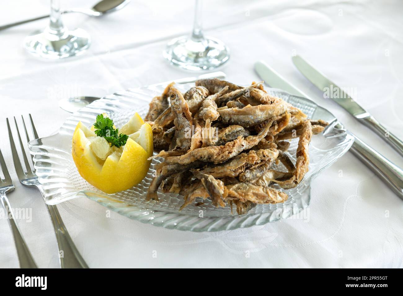 Plate of fried small freshwater fish with lemon Stock Photo - Alamy
