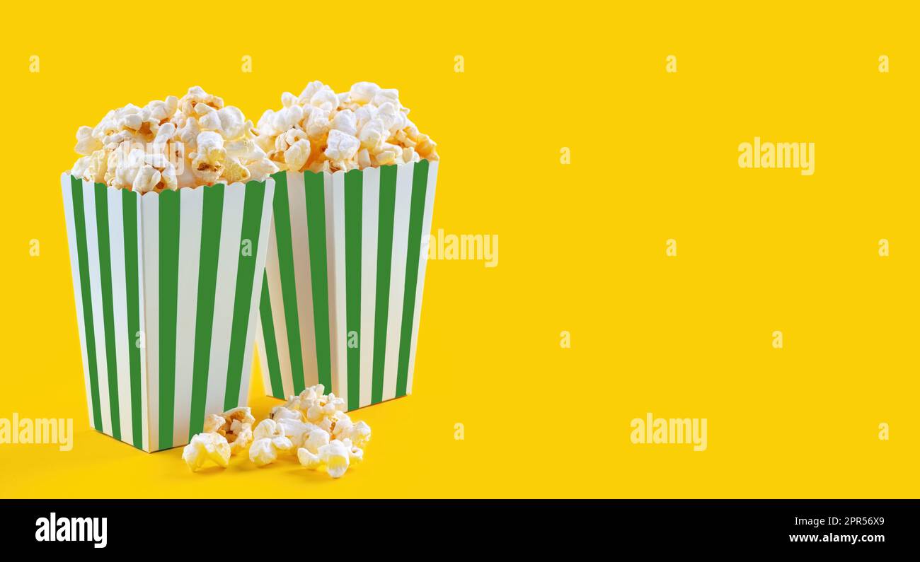 Two green white striped carton buckets with tasty cheese popcorn ...