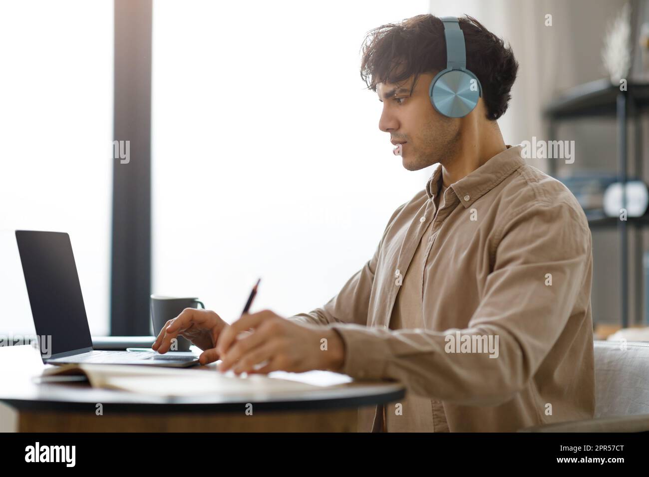 Young hispanic man taking headphones hi-res stock photography and ...