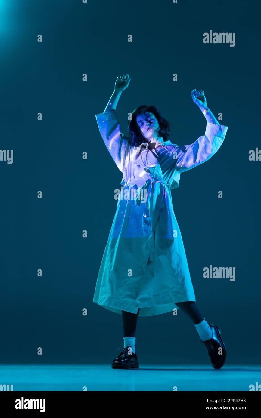 Portrait of dreaming adorable girl wearing trendy clothes posing with ...