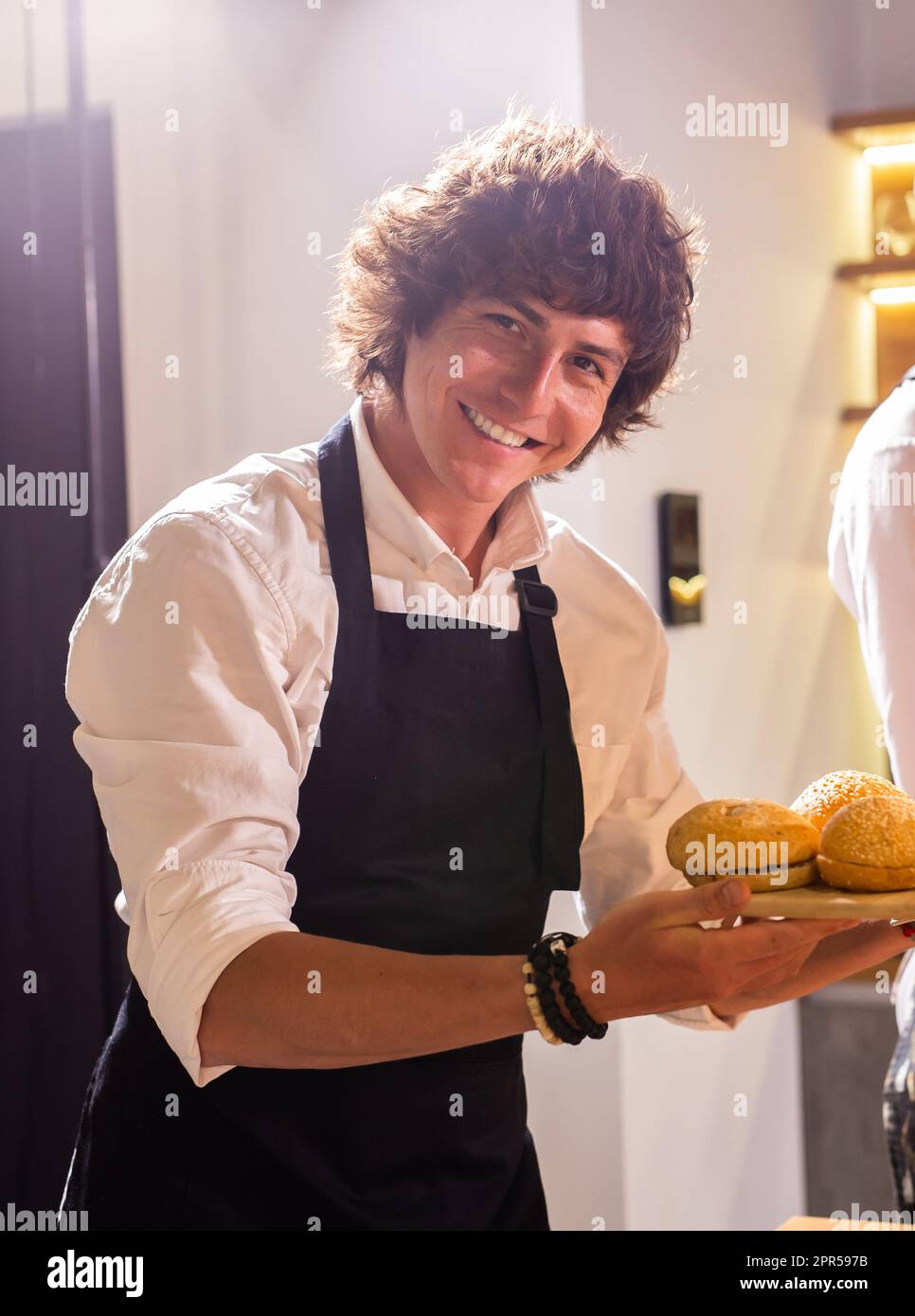 Happy confident young waiter entrepreneur smiling male small cafe ...