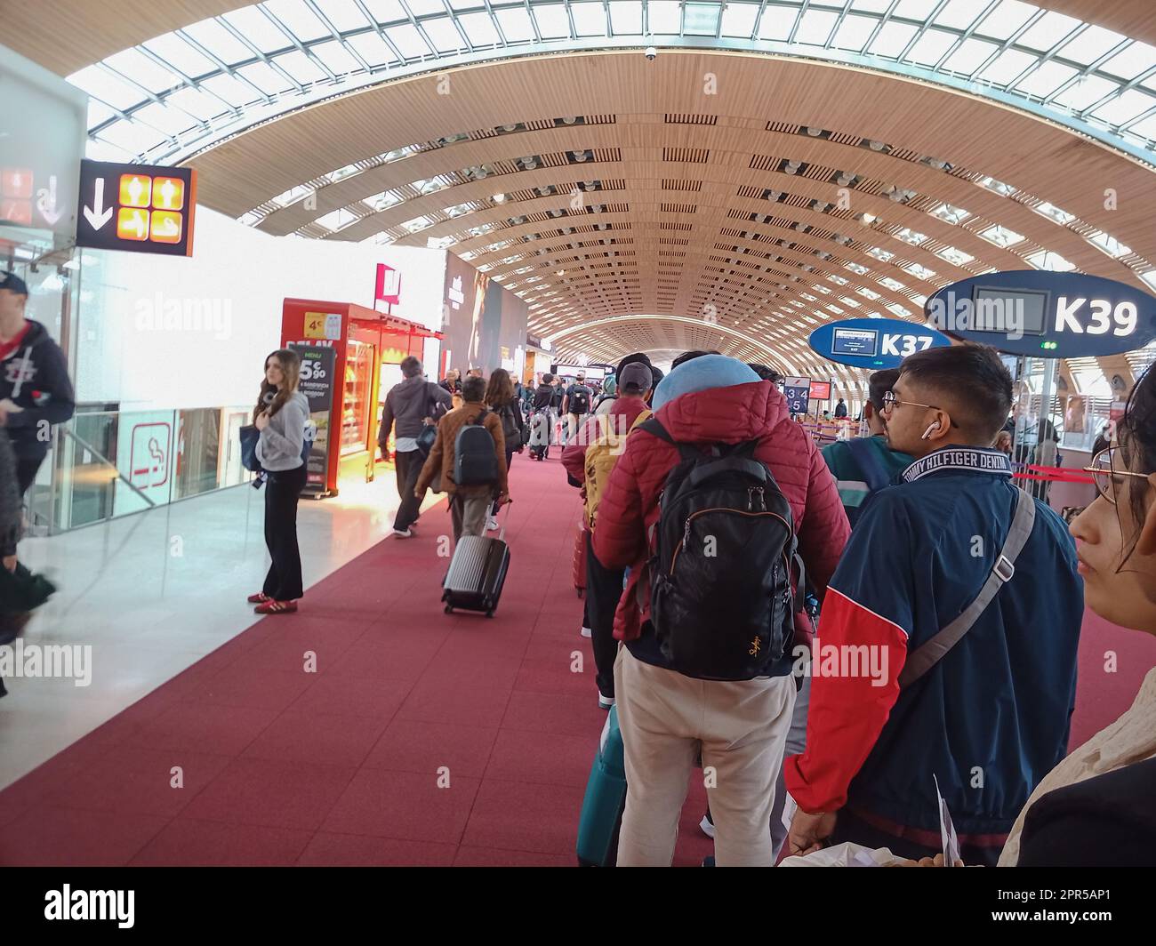 CDG airport, Paris, France, April 2023 - Passengers line up for aircraft boarding in the ...