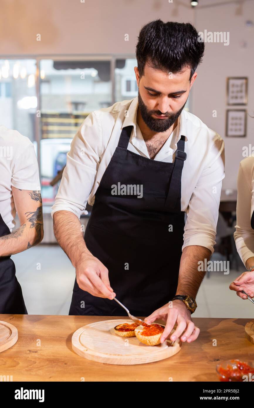 Male chef cooking burger in restaurant kitchen Stock Photo - Alamy
