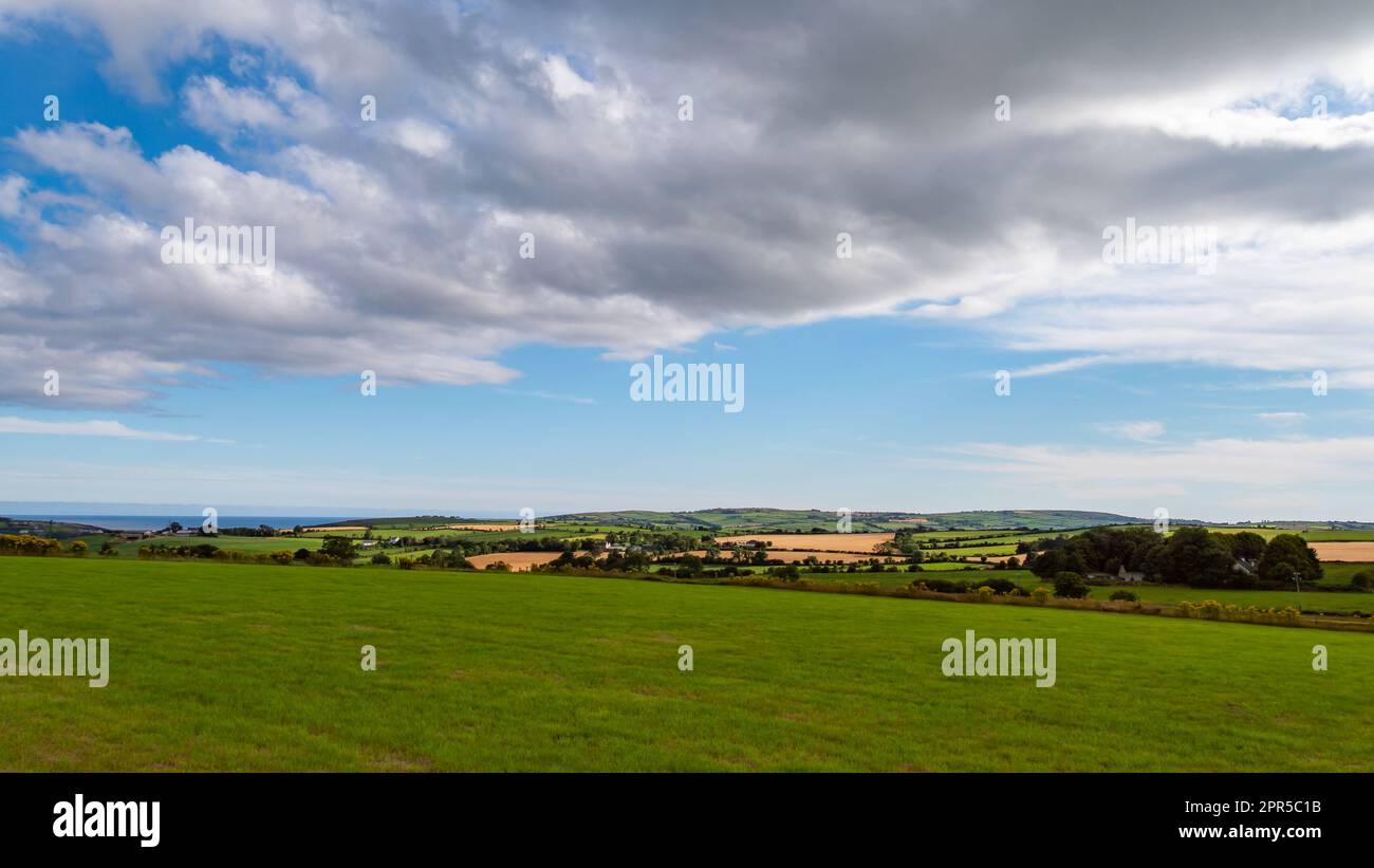 A huge cumulus cloud in the sky over the Irish countryside in summer ...