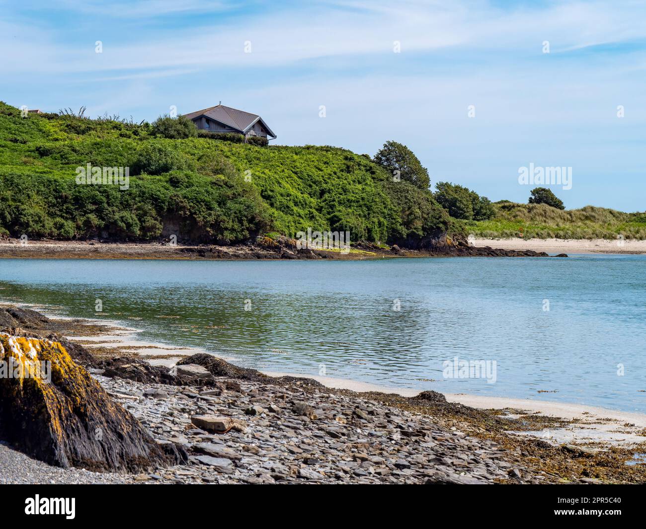 A house on a green hill by the sea, an Irish landscape. house near body ...