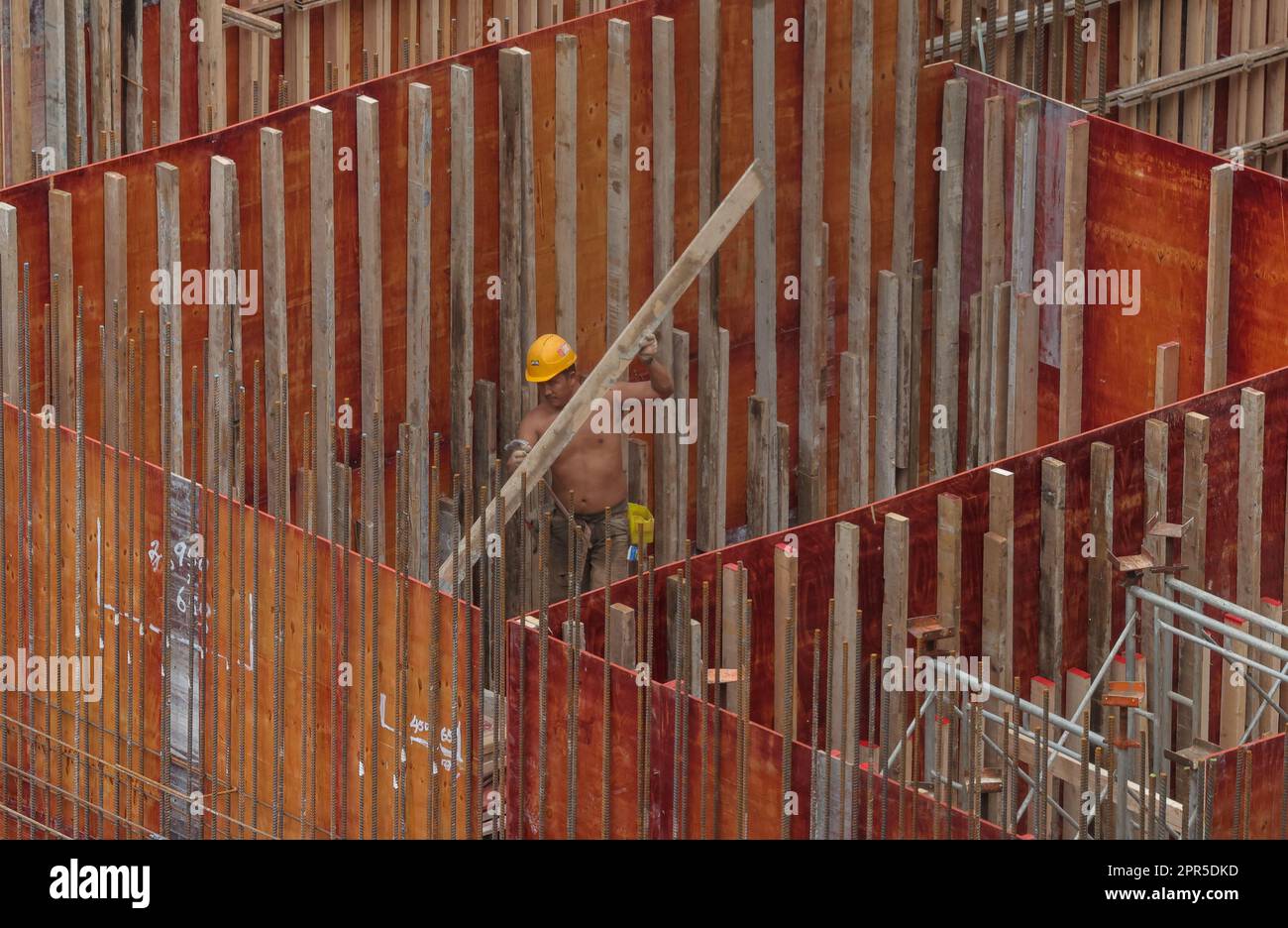 Site workers erect formwork at a construction site in Mongkok. 04APR23 ...