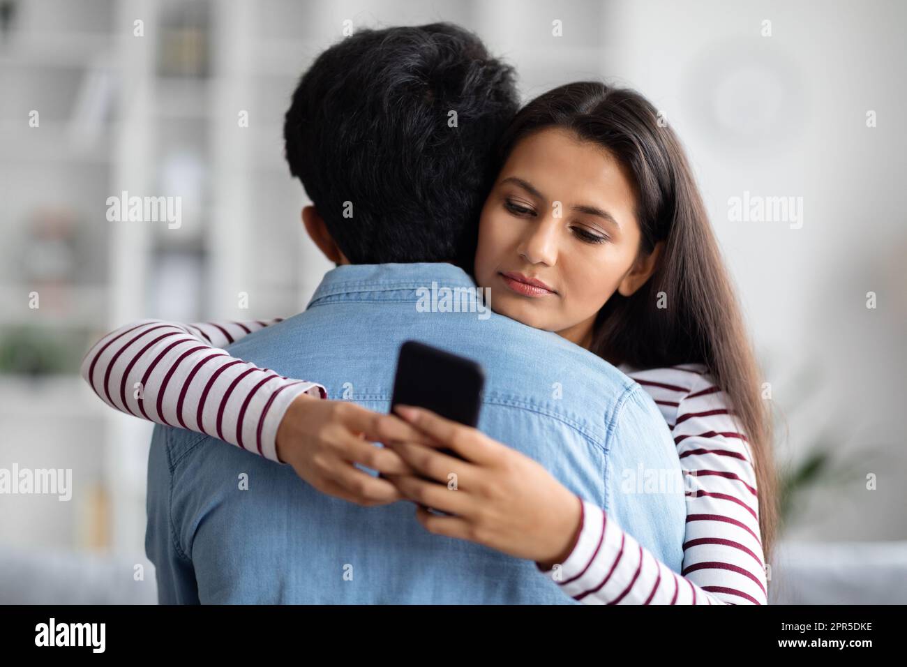 Pretty young eastern woman chatting while hugging her boyfriend Stock ... Pretty young eastern woman chatting while hugging her boyfriend Stock ...